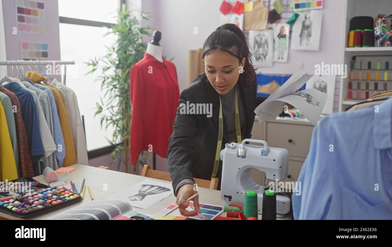 Hispanic woman sorting fabric swatches in a modern tailoring shop amid ...