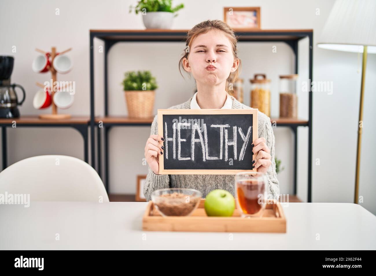 Blonde bombshell's hilarious breakfast antics, puffing cheeks, holding ...