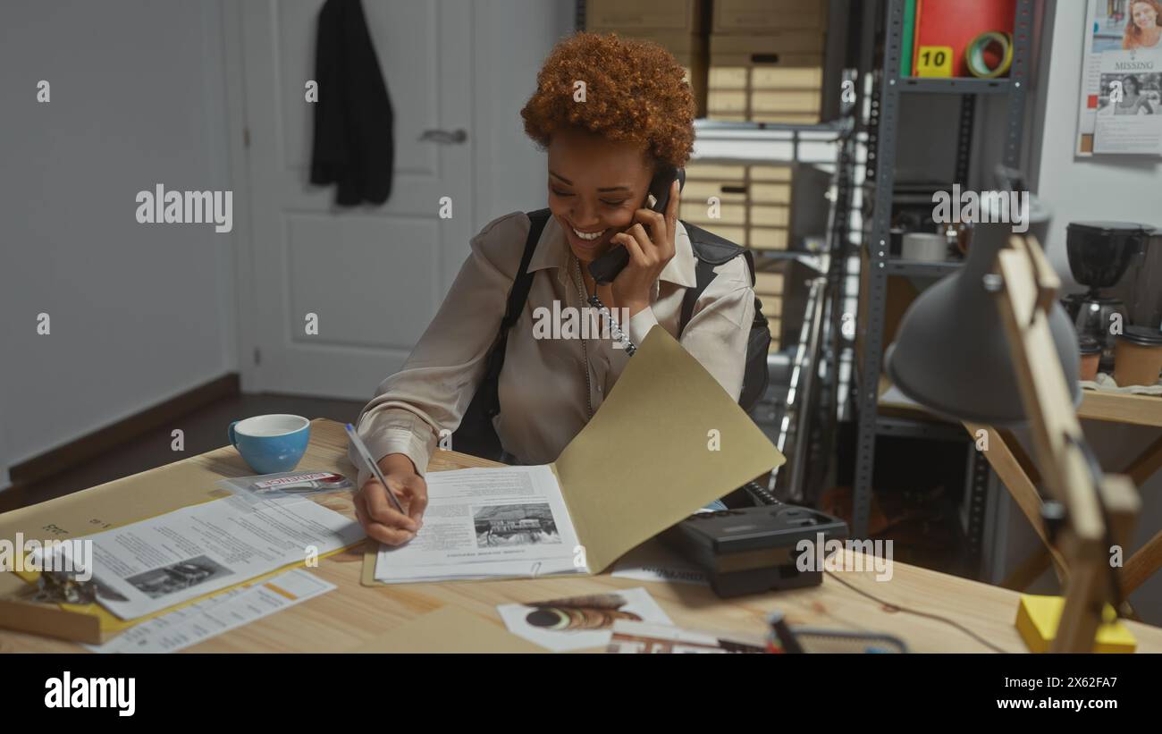 African american woman detective taking notes in a police station ...