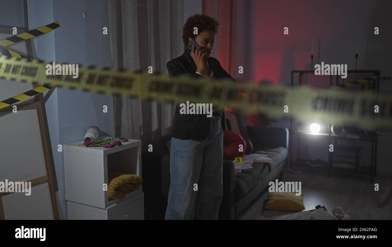 A concerned african american woman on a phone call in a dimly lit crime ...