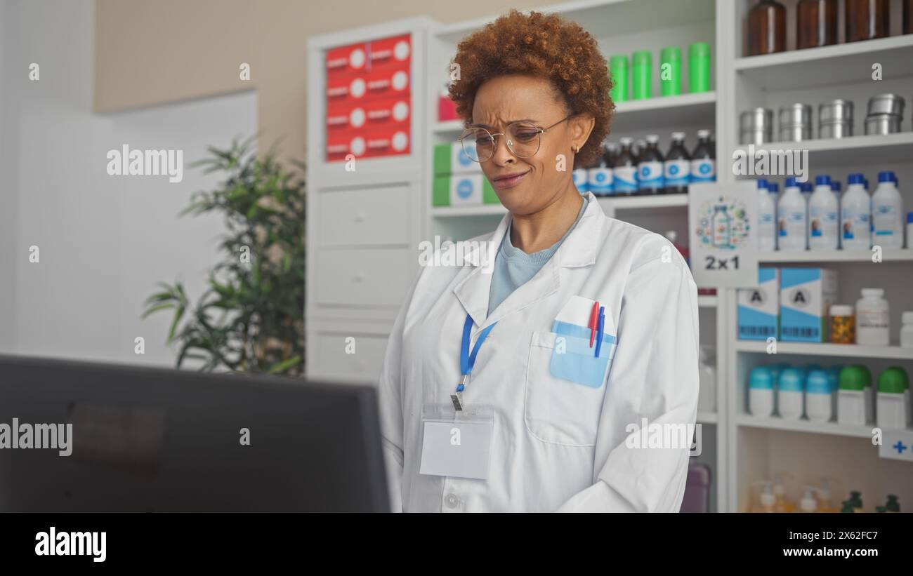 African american female pharmacist working indoors at a modern pharmacy ...