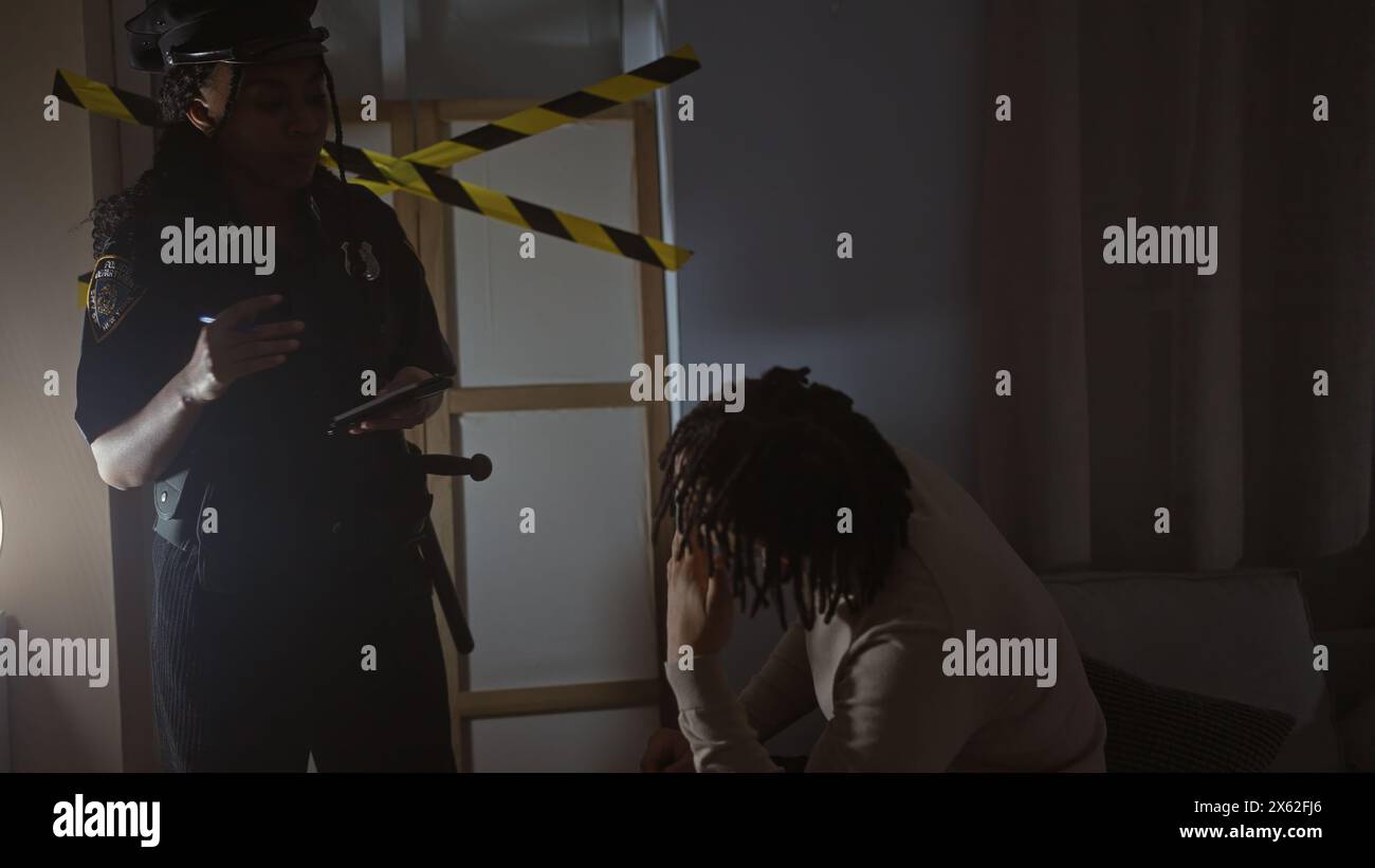 A policewoman interviews a man in a dimly lit indoor crime scene ...