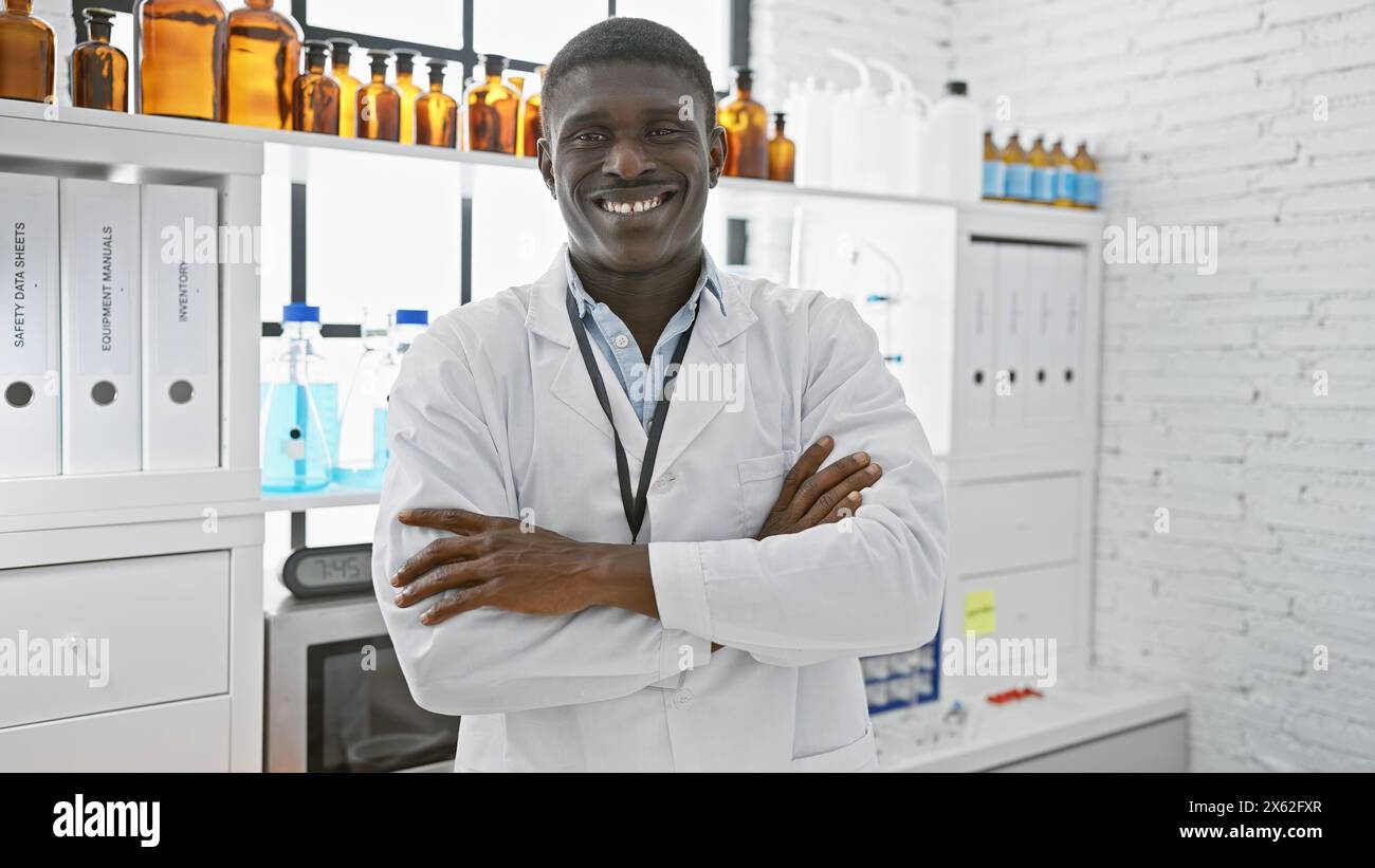 Confident african man in white lab coat standing with arms crossed in a ...