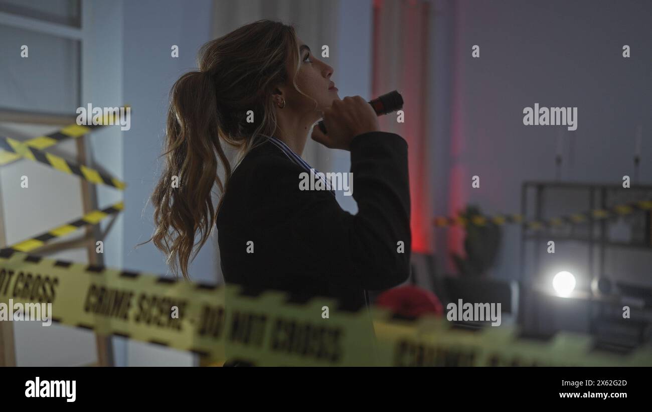 A young caucasian woman contemplates, holding a microphone in an indoor ...