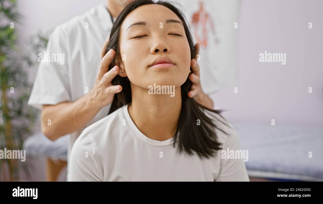 A woman receiving neck therapy from a male physiotherapist in a well-lit rehabilitation room ...