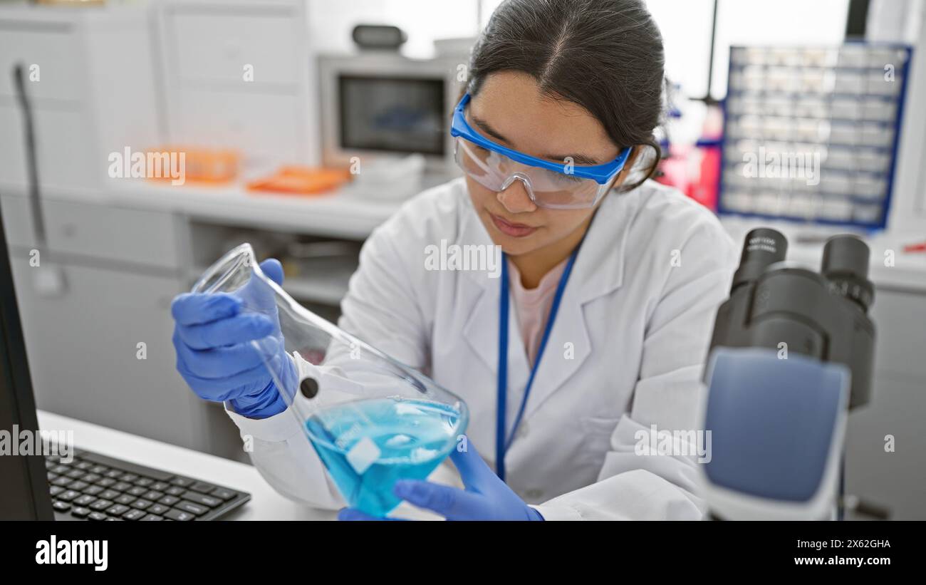 Hispanic woman scientist conducts experiment in laboratory setting ...