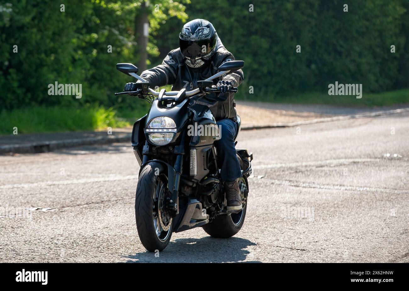 Stoke Goldington,UK - May 11th 2024: Man riding a 2011 Ducati Diavel ...