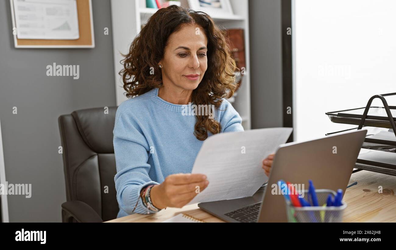 Senior woman reviewing document folder hi-res stock photography and ...