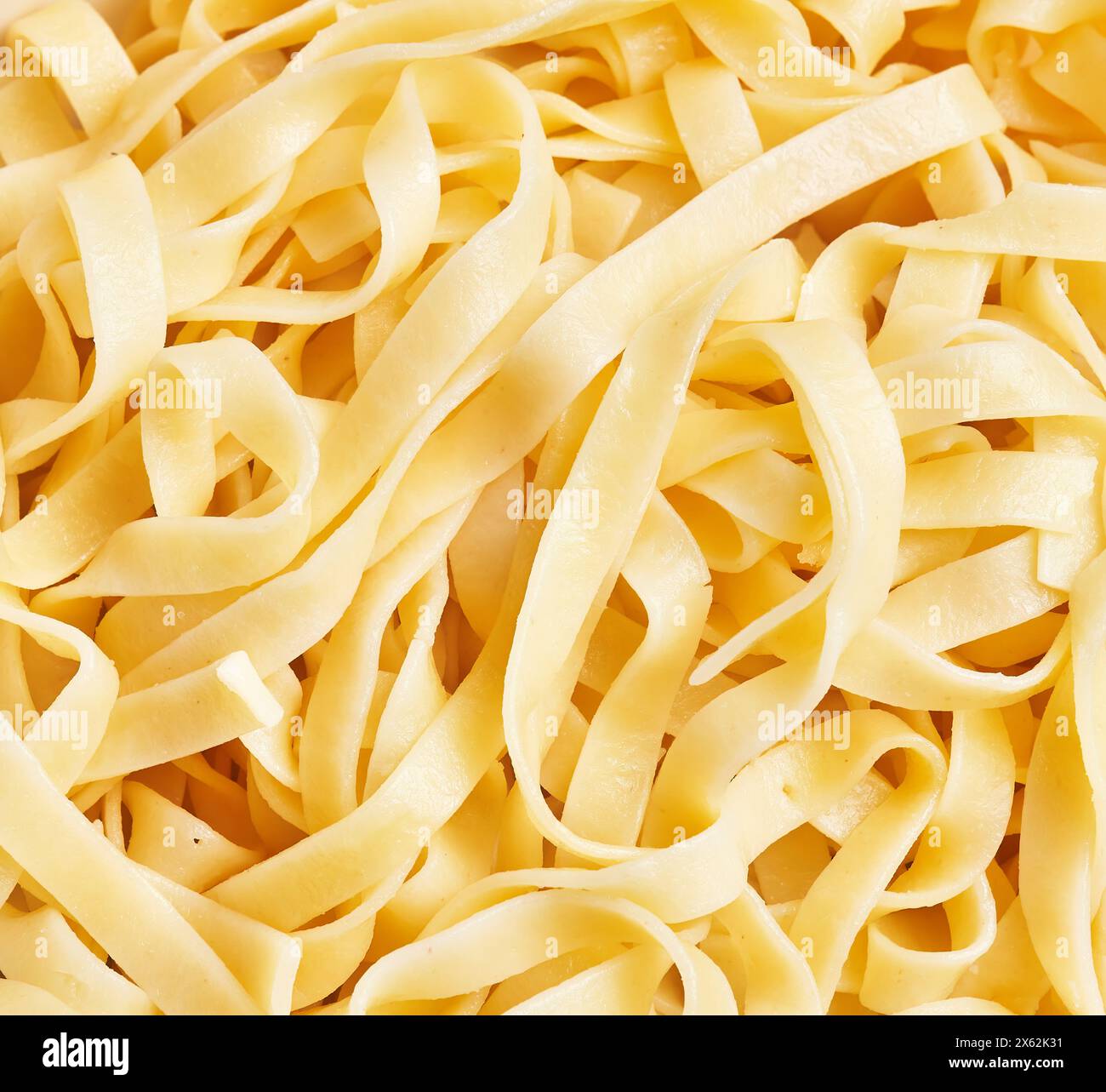 Close-up of fresh fettuccine pasta noodles texture for italian cooking ...