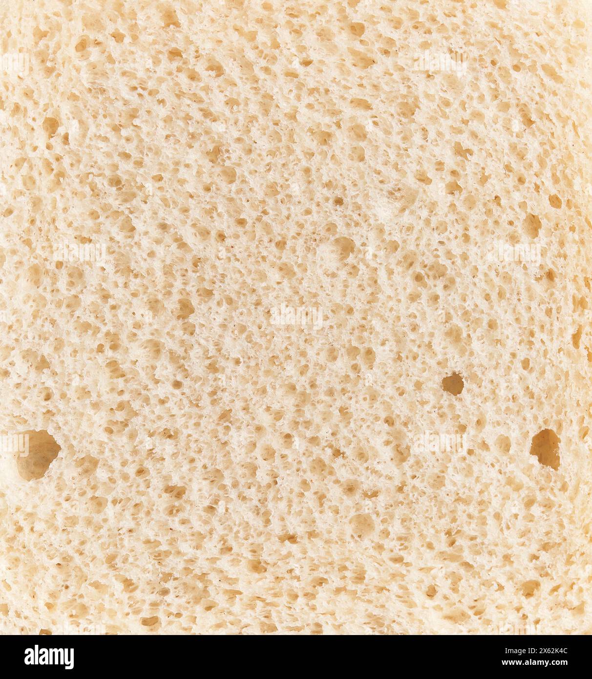 Close-up texture of a sliced white bread highlighting its porous ...