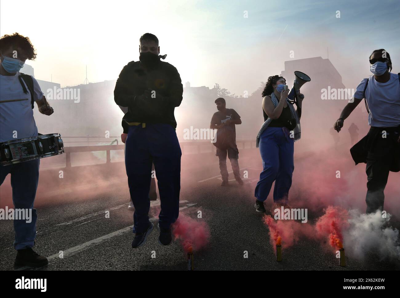 London, UK. 11th May, 2024. Protesters drum, chant and jump in the air ...