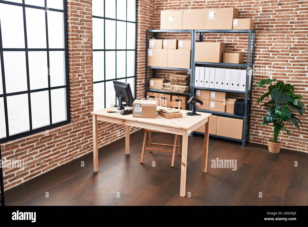 A modern office with computer, packages, shelves, plant, desk, barcode ...