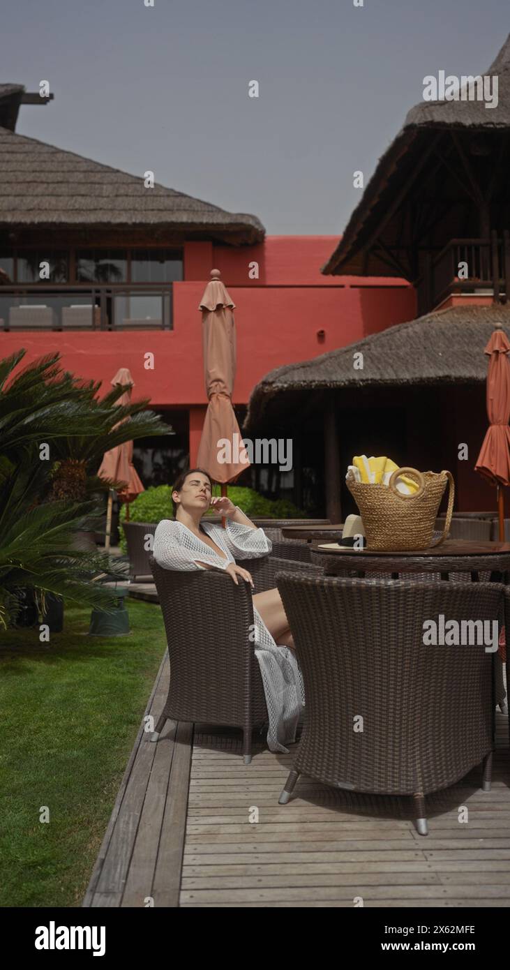 A relaxed woman enjoys tranquility at a luxurious bali resort ...