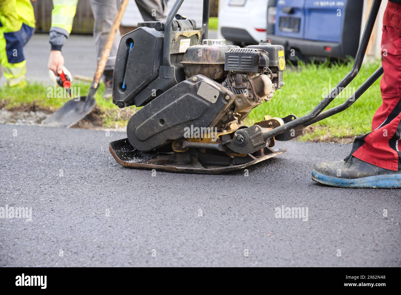 Construction Worker Compacting Asphalt With Vibratory Plate - Close-up ...