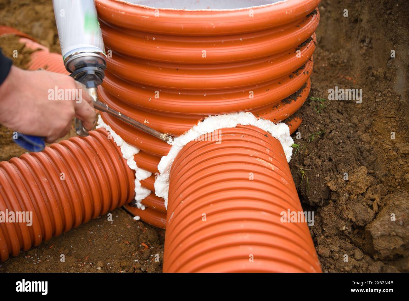 Construction Worker Compacting Pipe Connections With Filling Foam ...