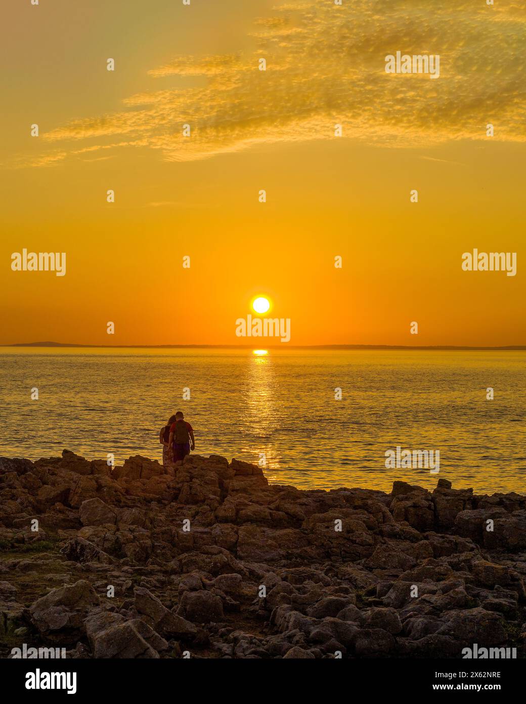 A Couple enjoy a romantic sunset at Rest Bay, Porthcawl, UK. 10th May ...