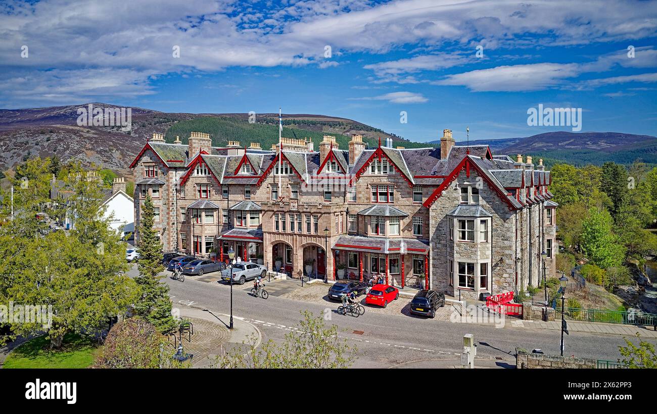 Braemar village Aberdeenshire Scotland Mar Road and cyclists passing ...