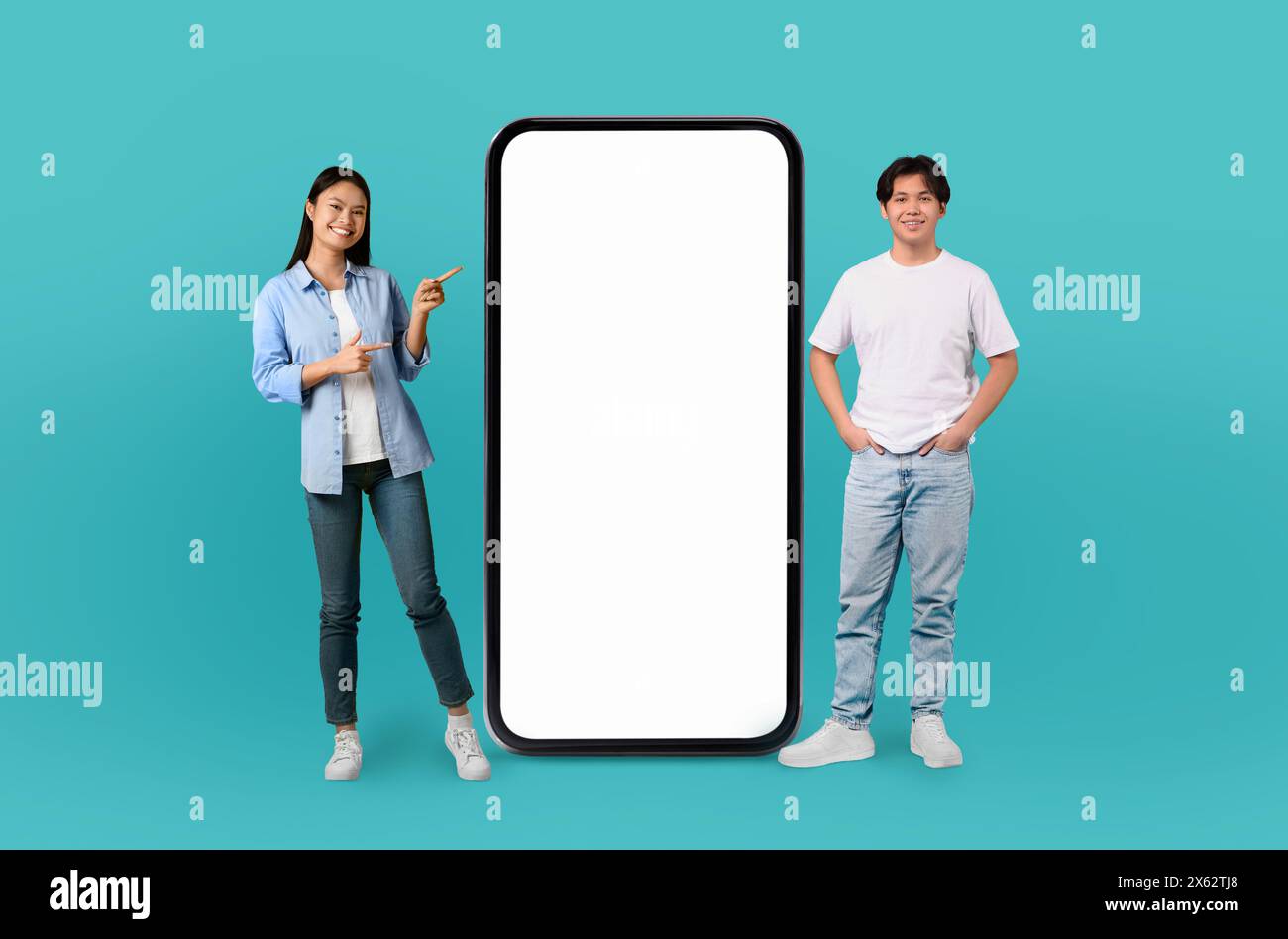 Korean Young Man and Woman Presenting a Giant Smartphone Stock Photo ...
