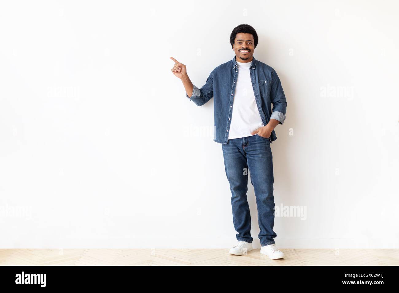 Man Standing in Front of White Wall Stock Photo - Alamy