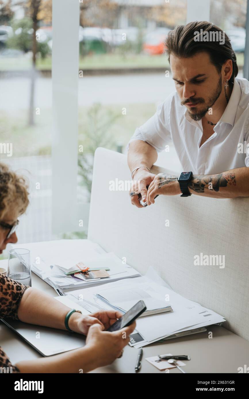 Creative multi generational team discussing business strategy in office ...