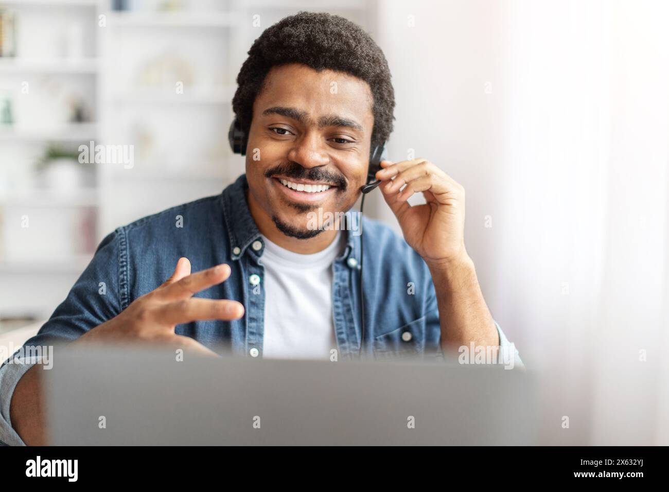 Smiling Young Man Engaging in Cheerful Video Call Stock Photo - Alamy