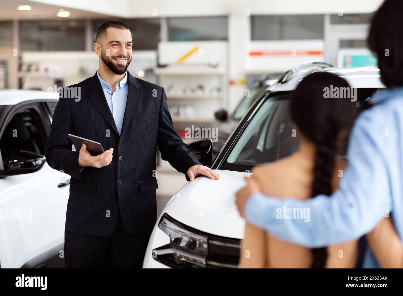 Professional car salesman presenting features hi-res stock photography ...