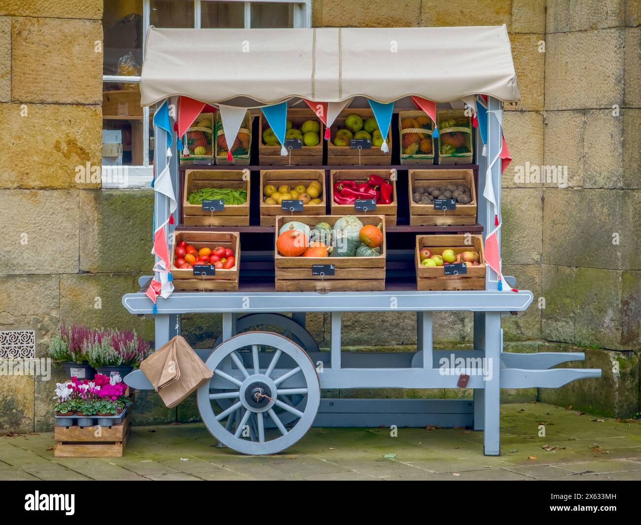 Blue wooden hand cart decorated with red white and blue bunting ...