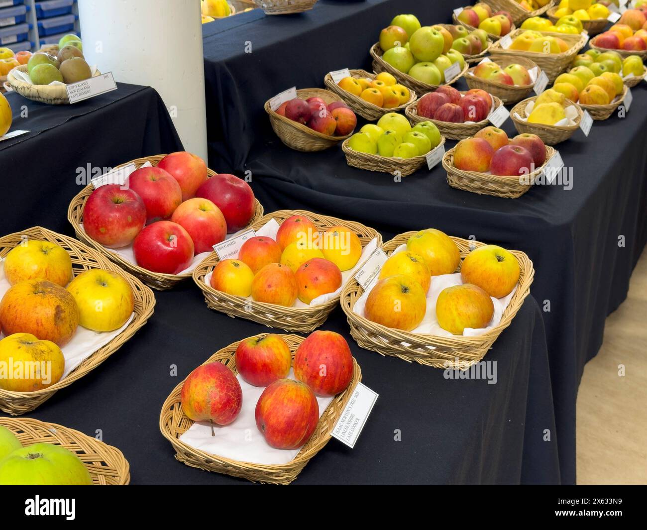 Baskets of apples displayed in small baskets at a fruit and vegetable ...