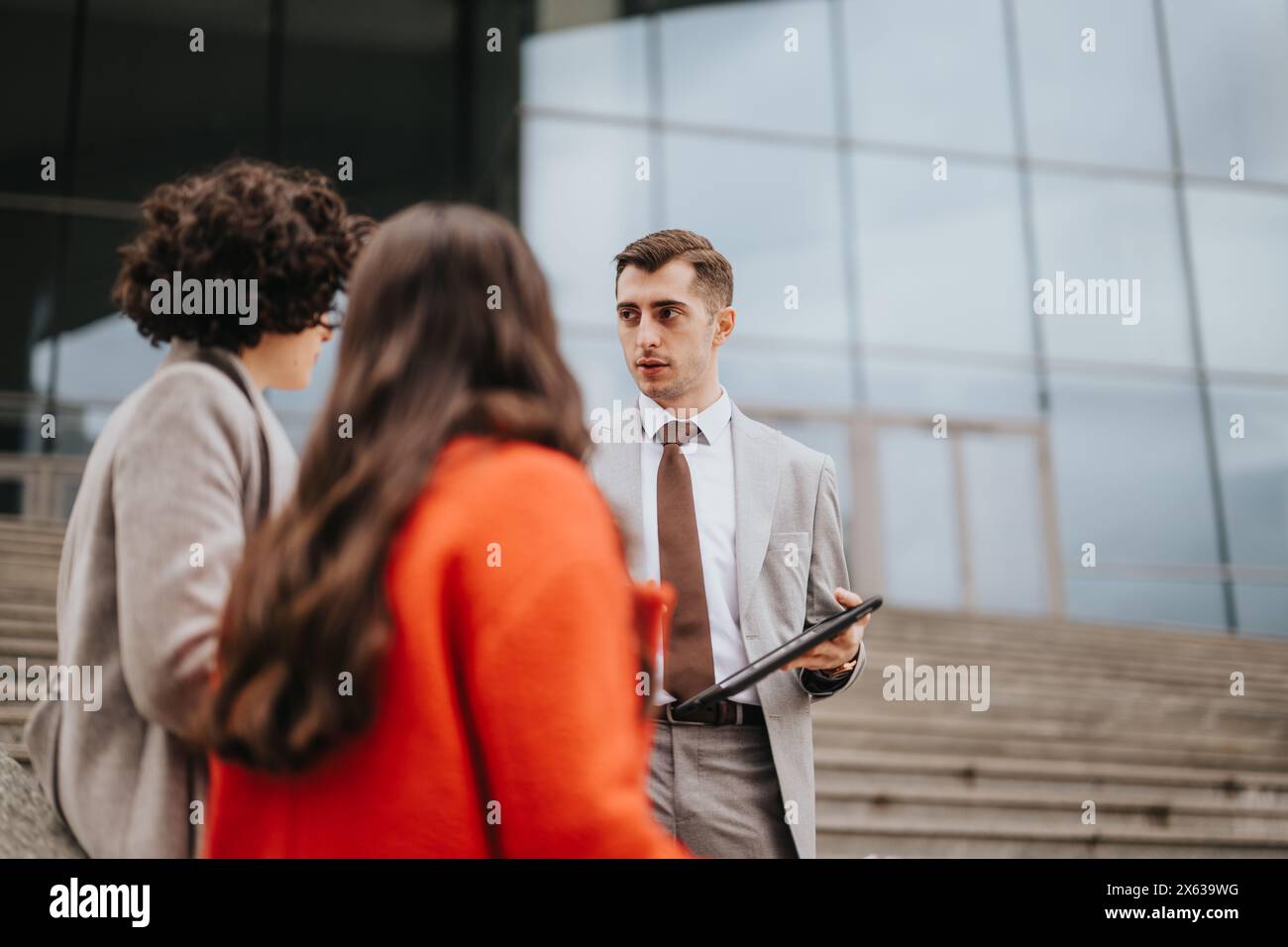 Business associates engaged in a serious discussion outdoors Stock ...