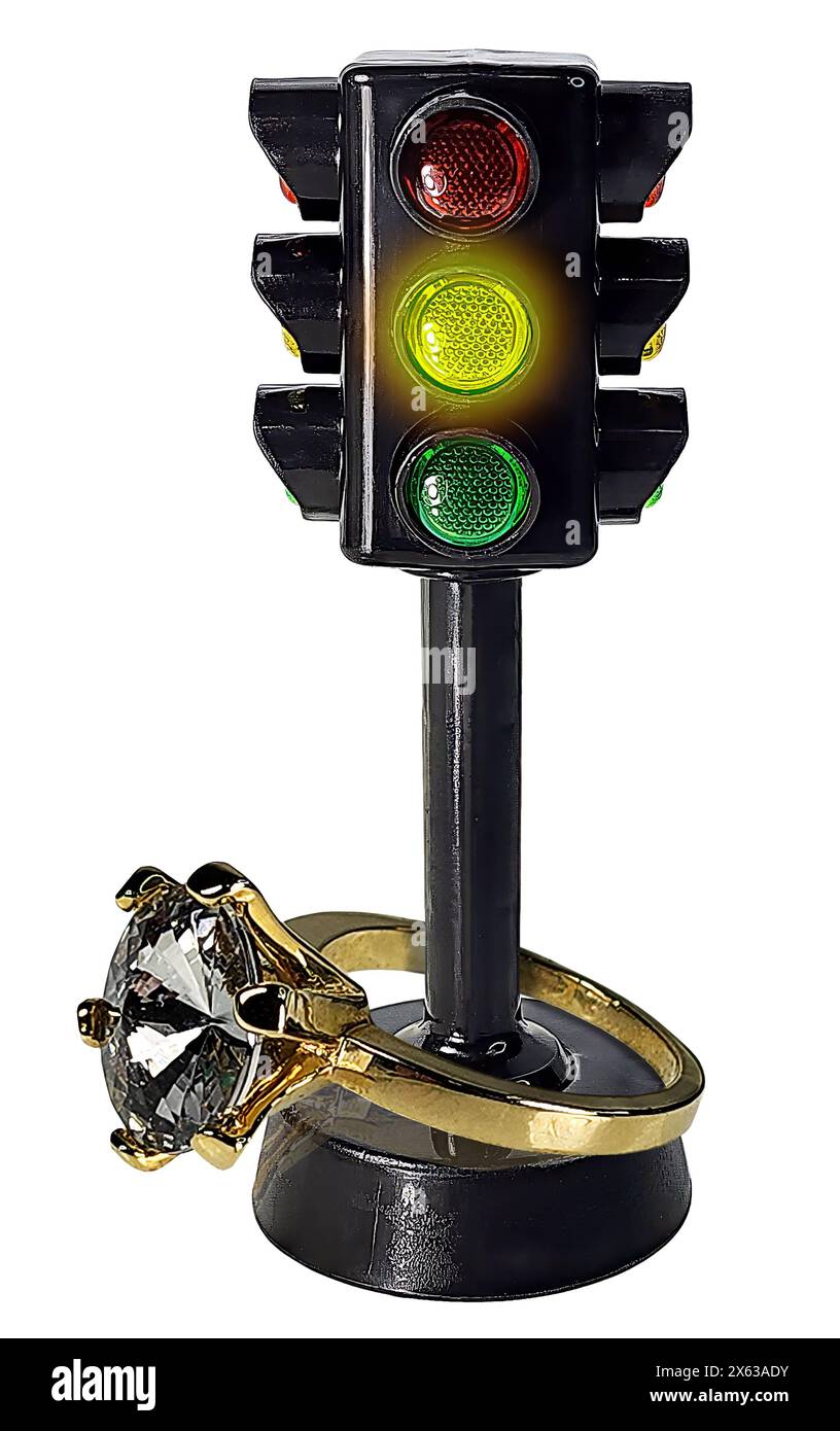 A large gold diamond ring and traffic light to show giving pause about ...