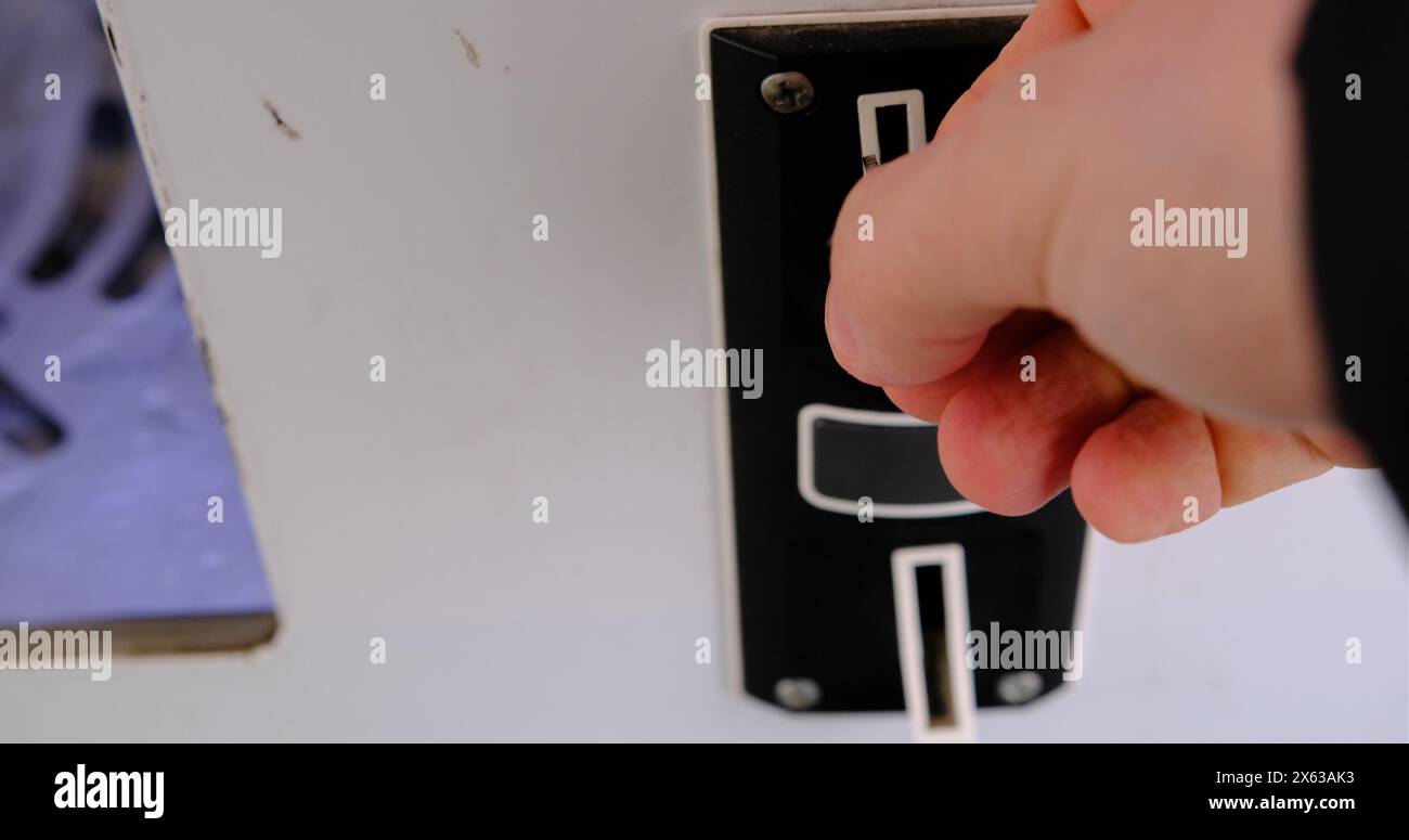 Inserting one coin into water filter vending machine water filter ...