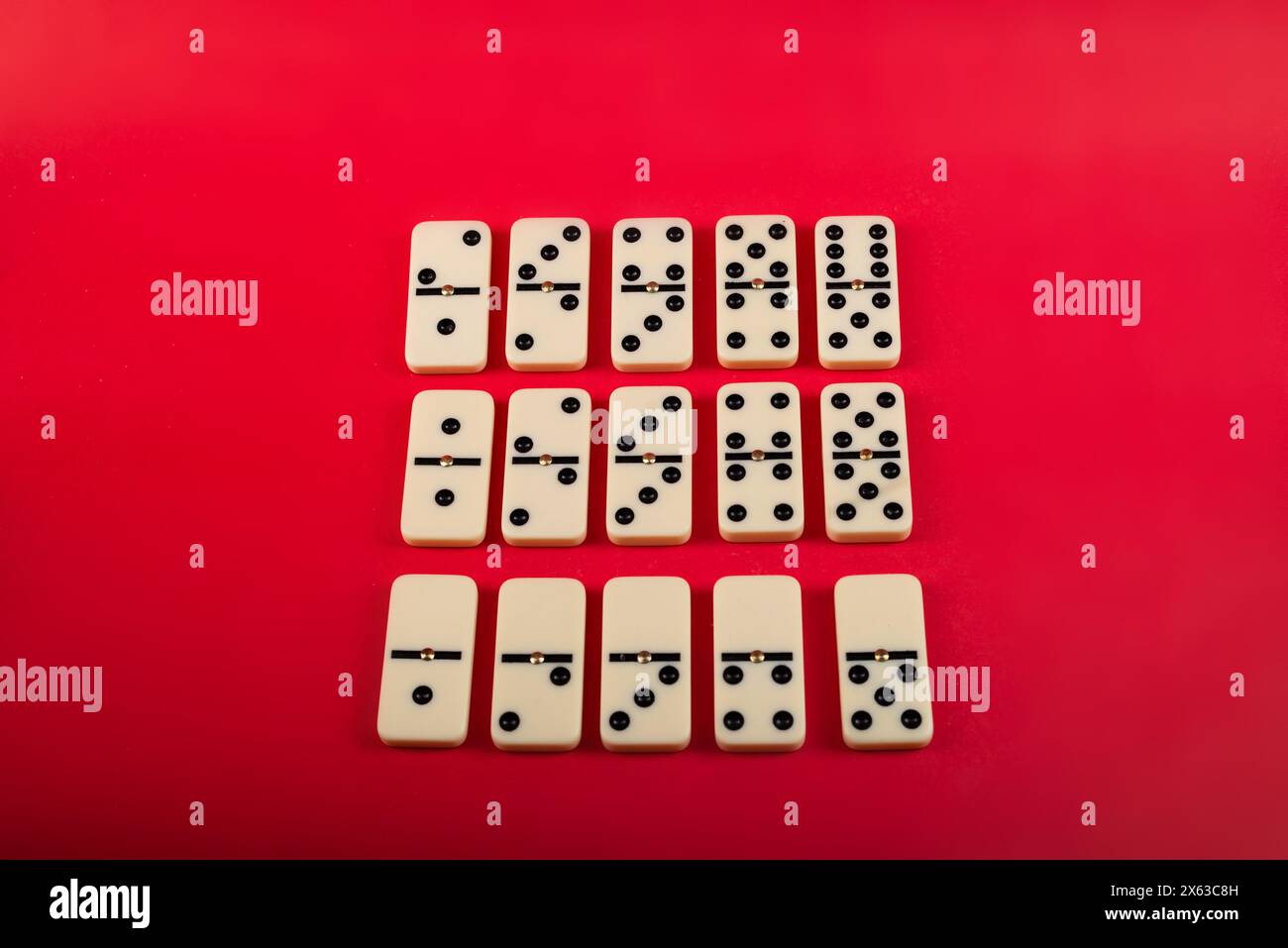 Dominoes on a red background. White Bones Board Game Stock Photo - Alamy