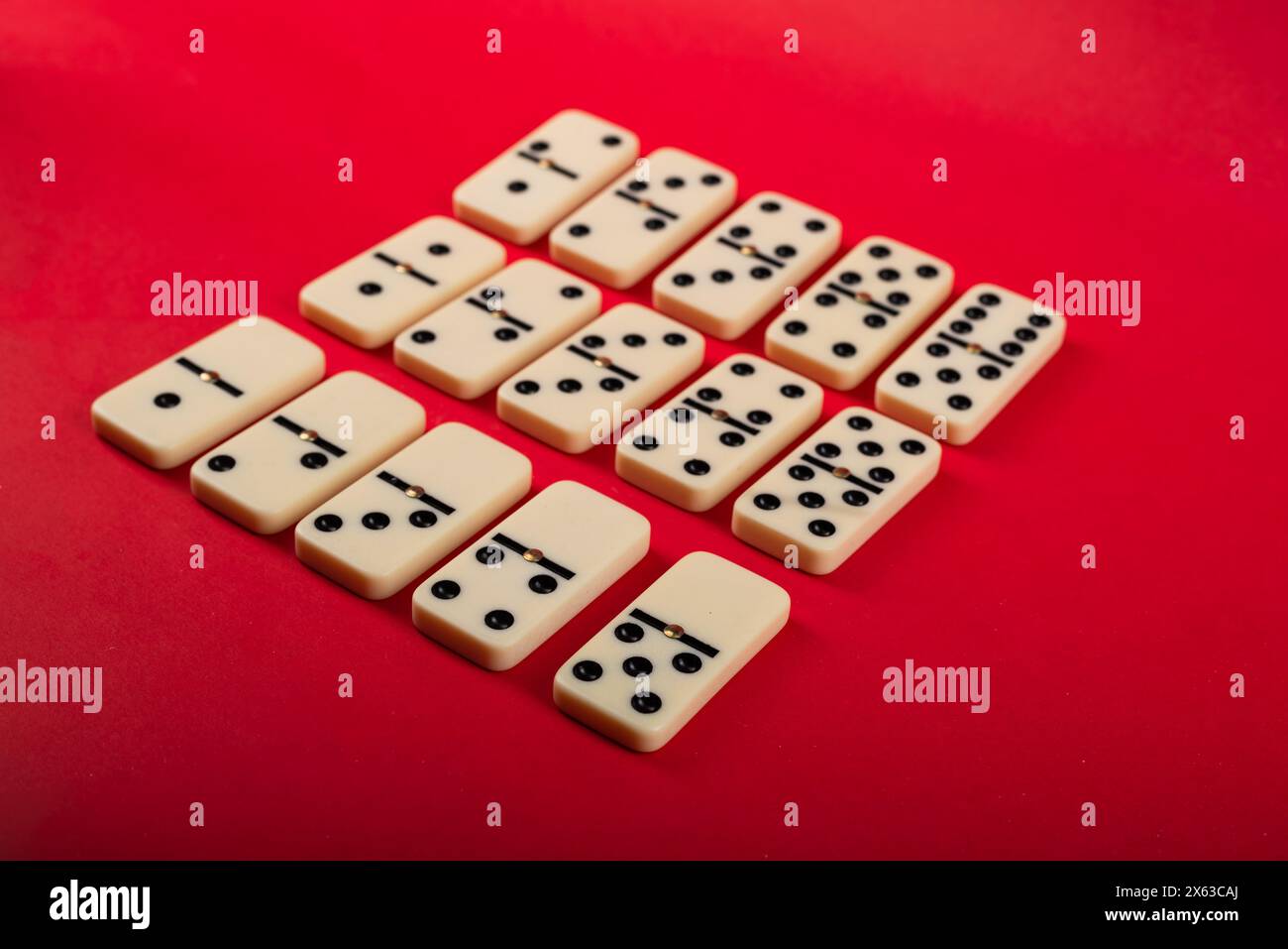 Dominoes on a red background. White Bones Board Game Stock Photo - Alamy