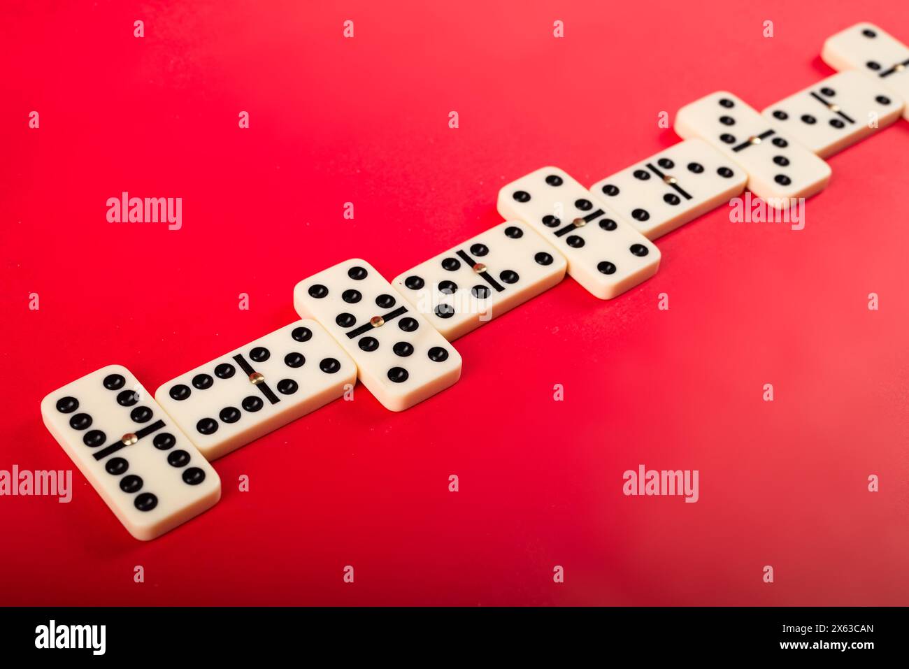 Dominoes on a red background. White Bones Board Game Stock Photo - Alamy