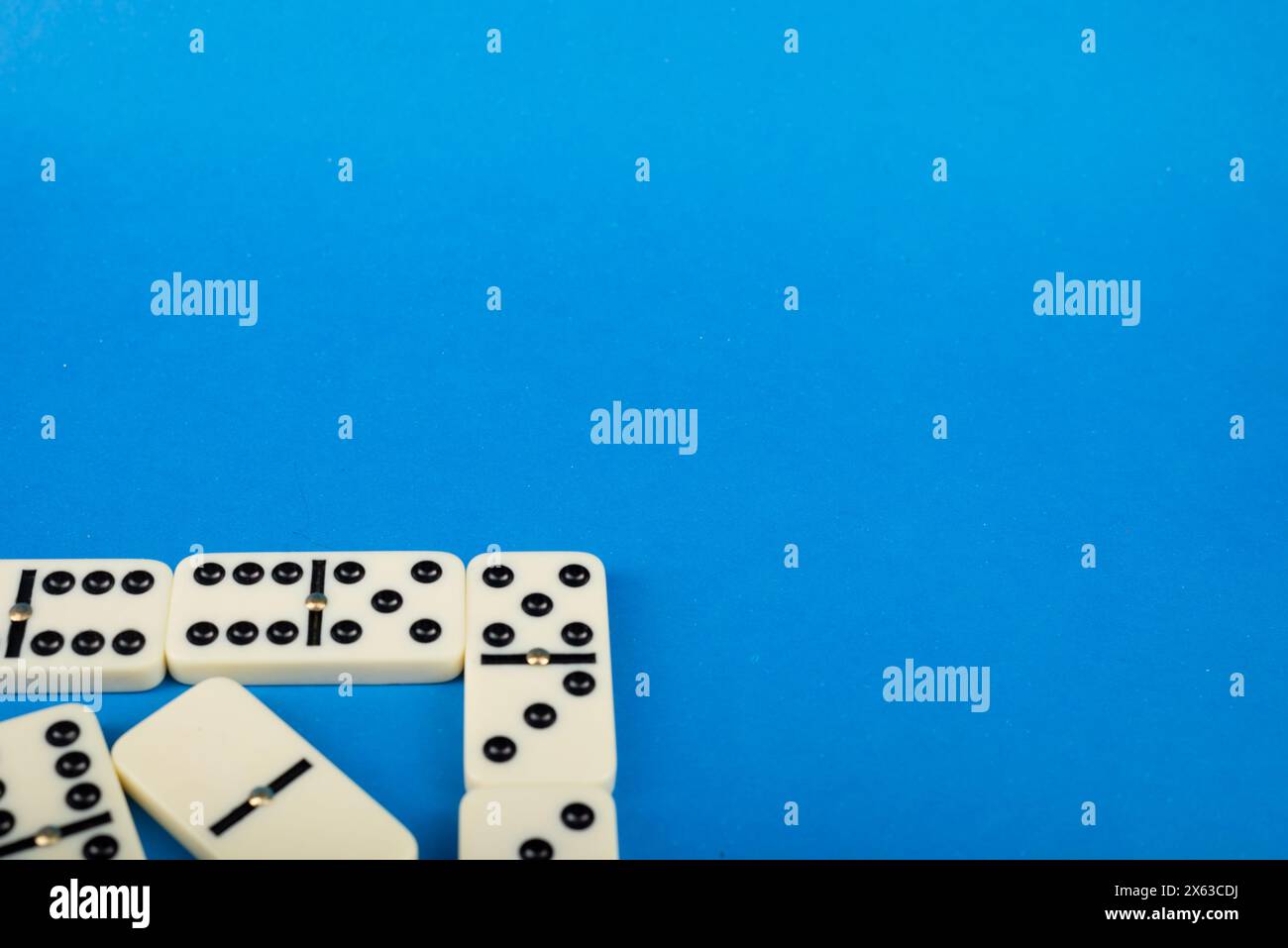 Connected dominoes on a blue background. board games concept Stock ...