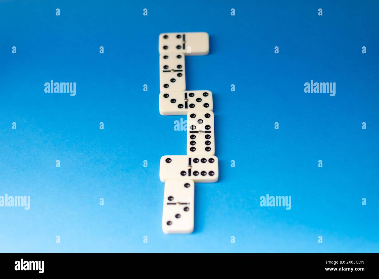 Connected dominoes on a blue background. board games concept Stock ...