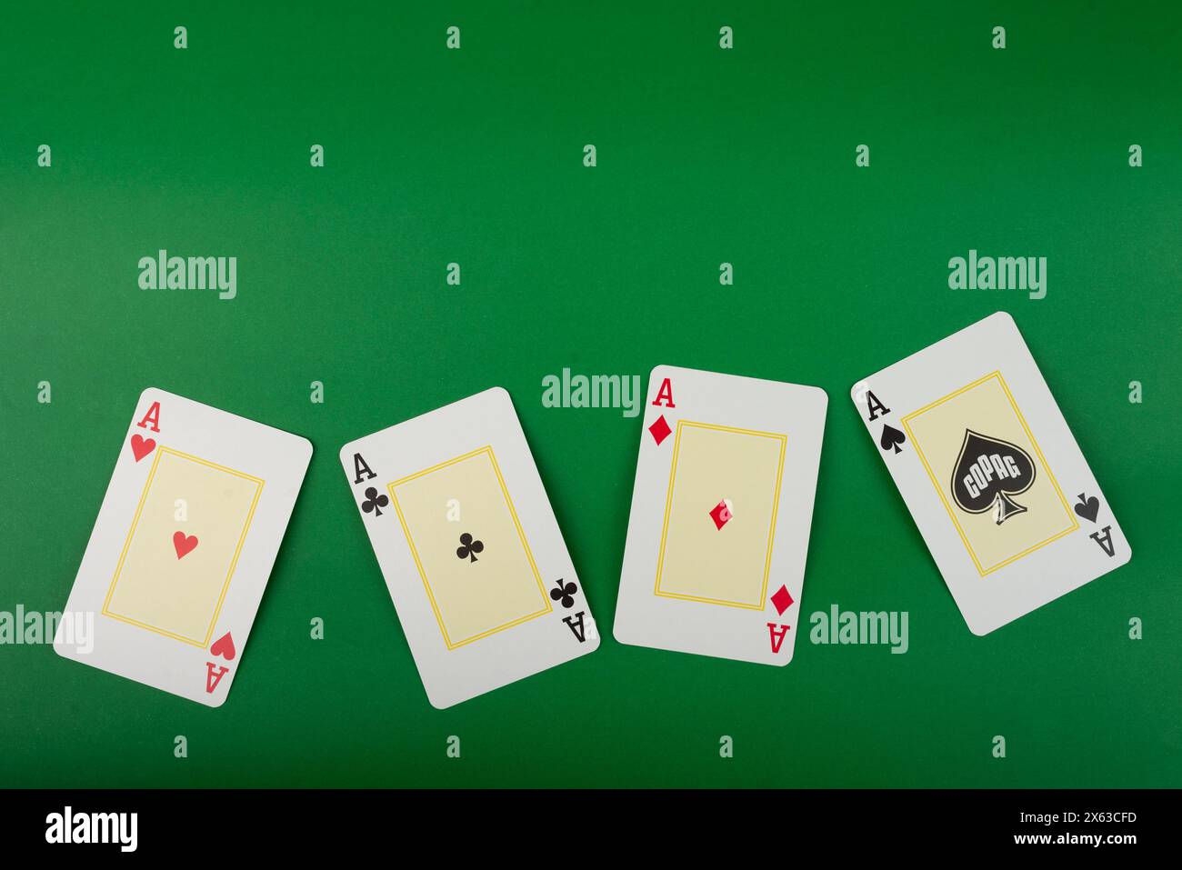 Playing cards isolated on green background. Gambling Stock Photo - Alamy