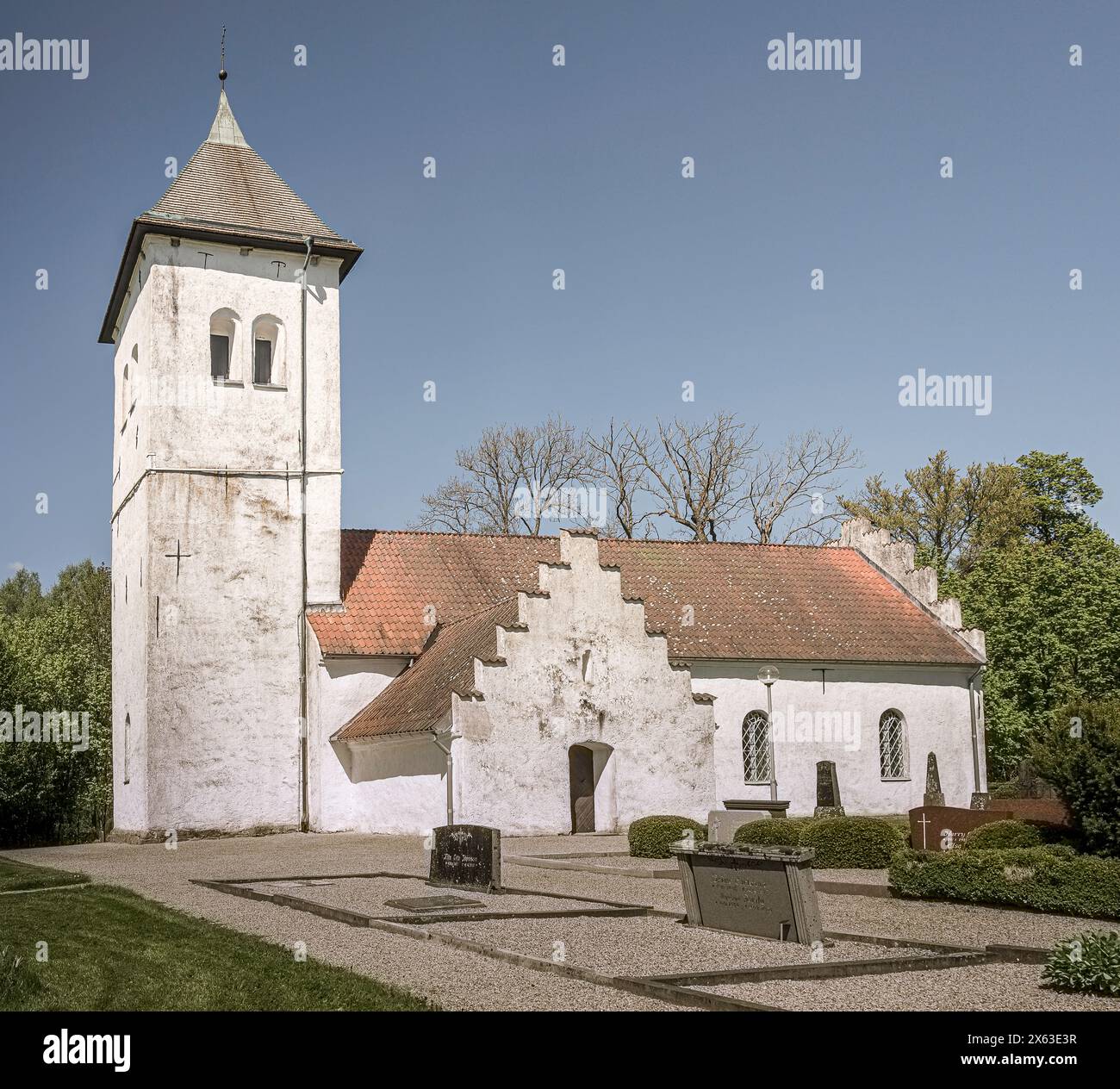 whitewashed Scandinavian church with towers reaching for the blue sky ...