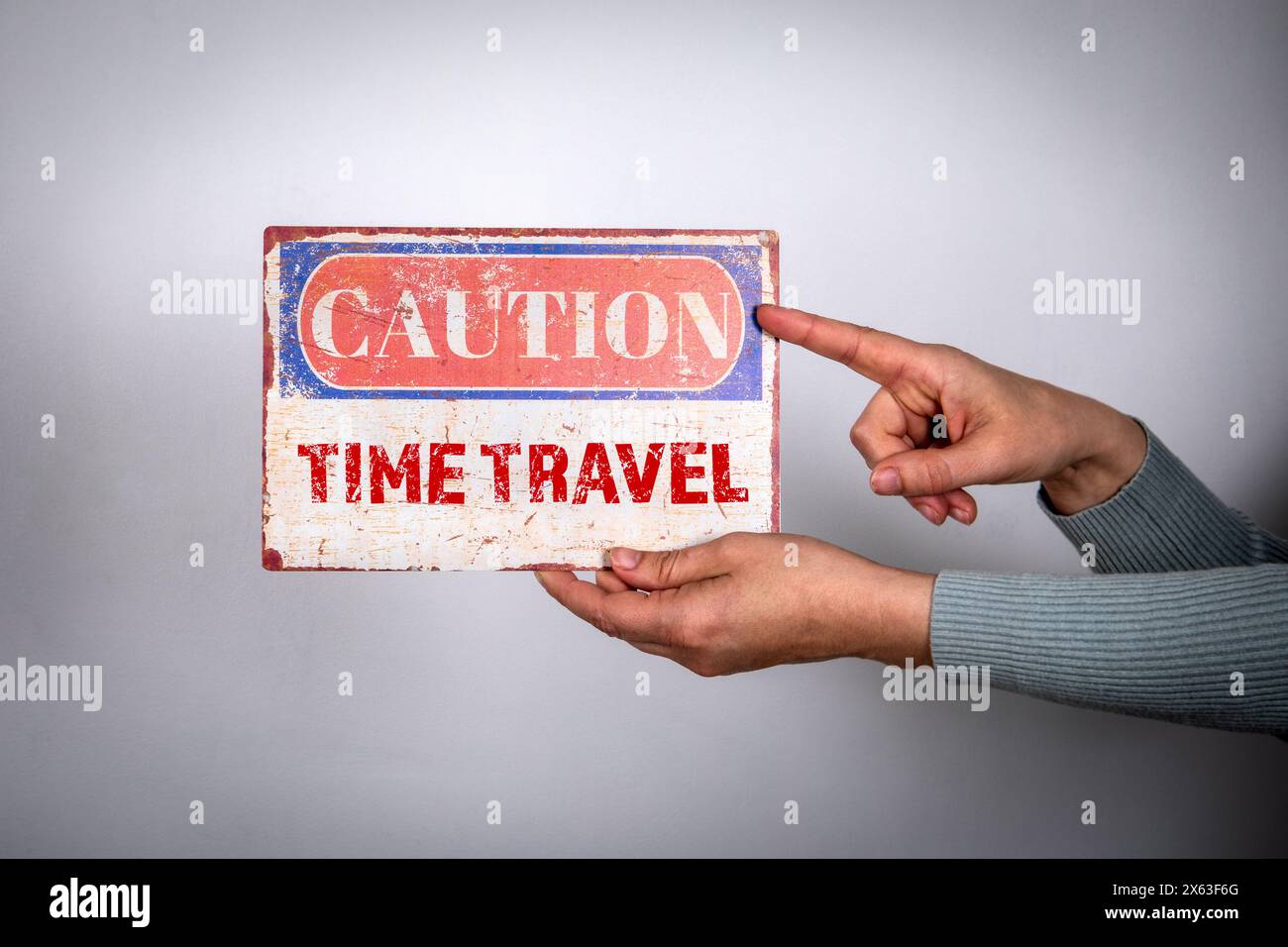 Time Travel Concept. Caution sign with text in woman hand on white ...