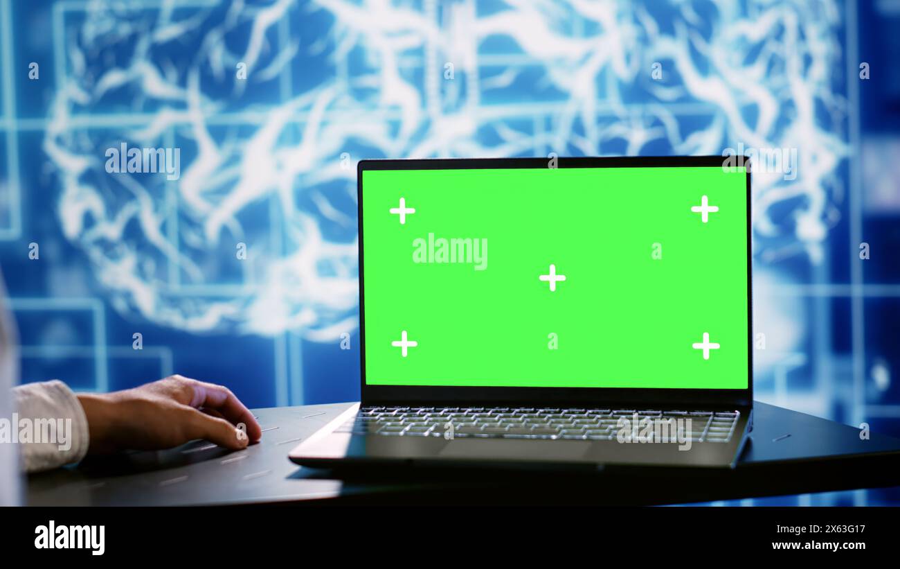 Computer scientist using green screen laptop to implement artificial intelligence parallel ...