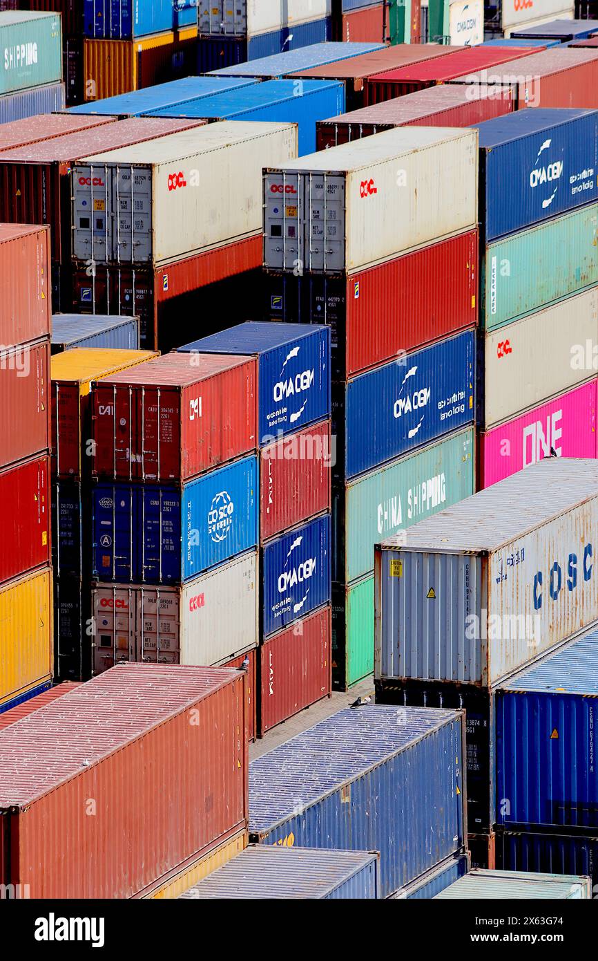 A large stack of shipping containers gives an impression of a patchwork ...