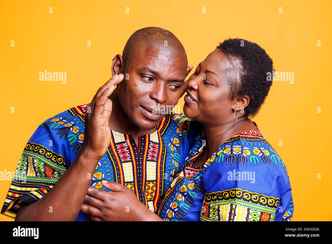 African american man listening to wife whispering with smile on face ...