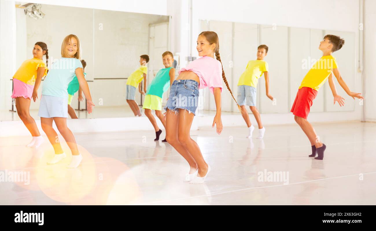 Group of kids training modern dance moves Stock Photo - Alamy