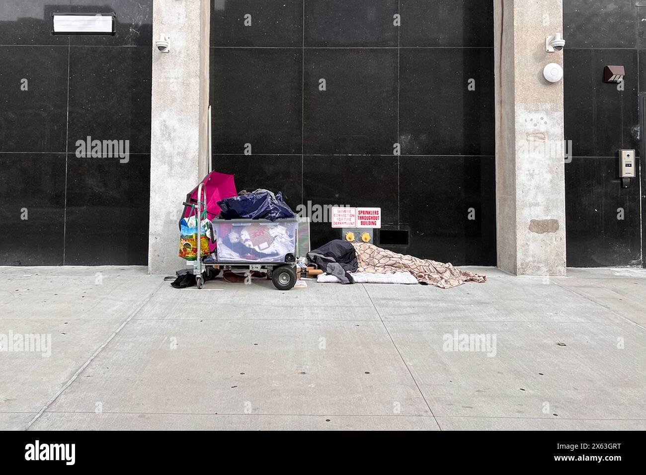 New York, United States. 09th May, 2024. An unhoused person sleeps on a ...