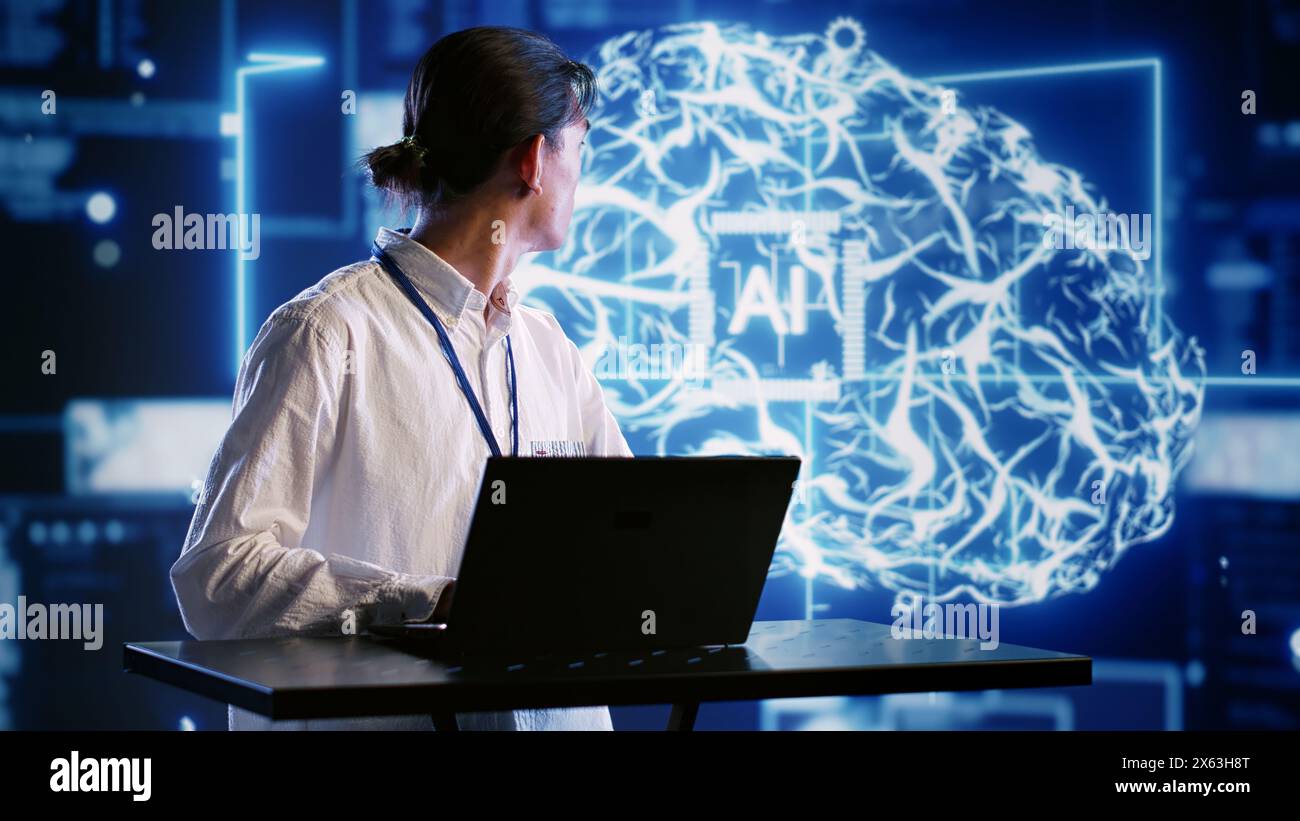 Admin using laptop to visualize artificial intelligence neural networks made up of ...