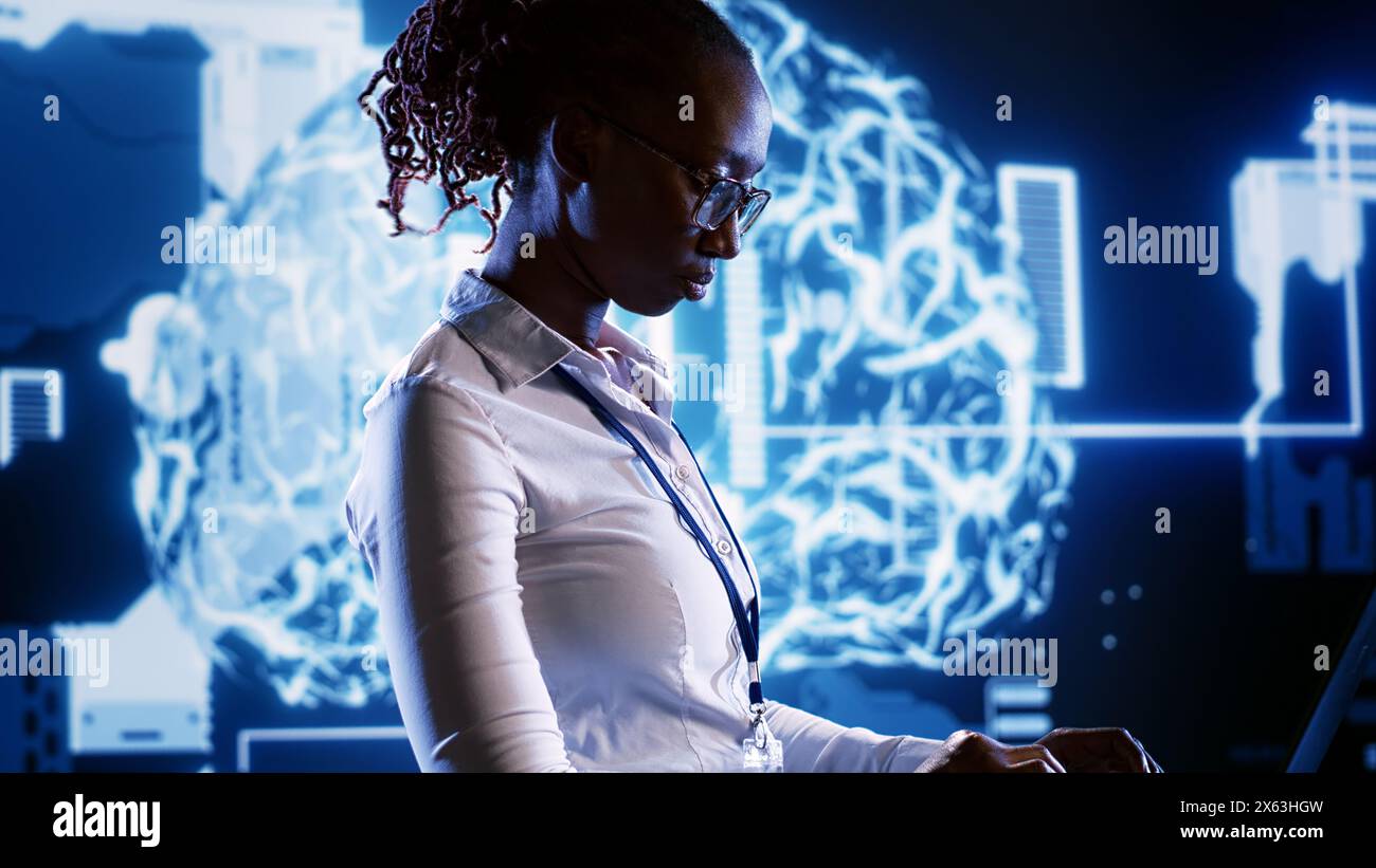 African american woman writing artificial intelligence script code in startup workspace on ...