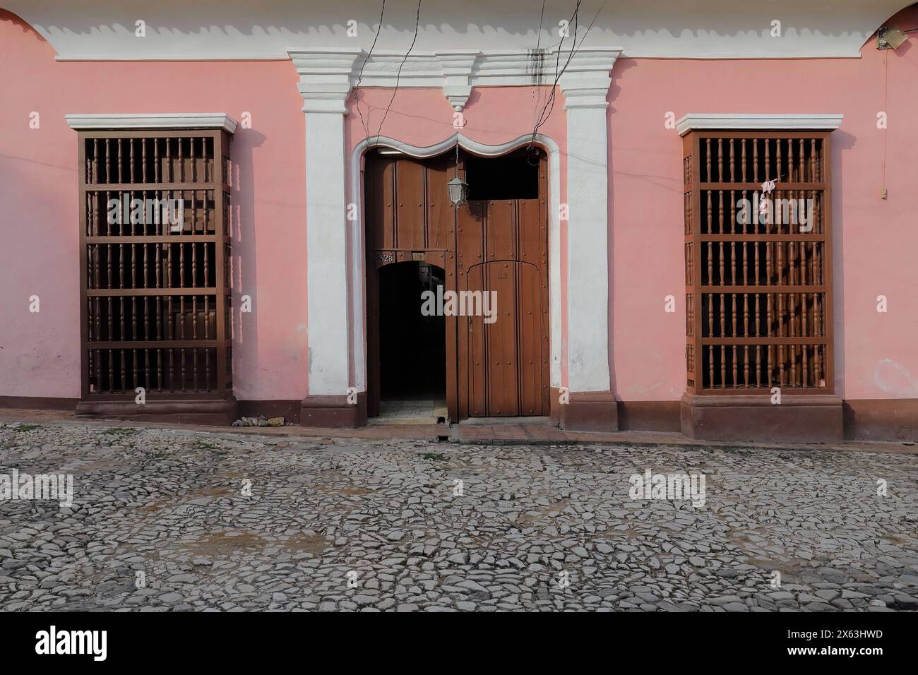 267 Pink colored facade of colonial house with main and wicket door on ...