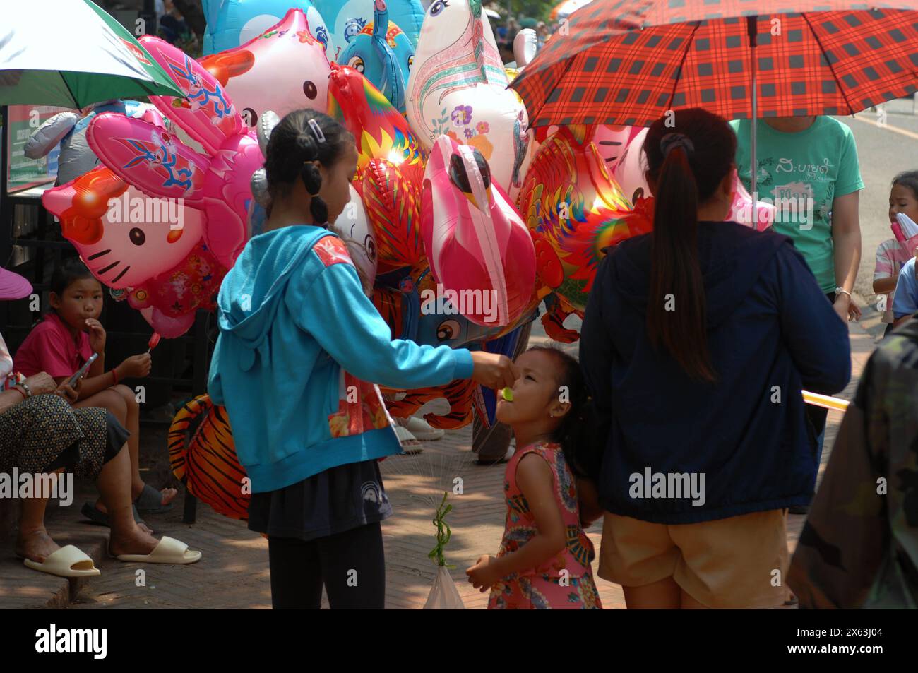 Colourful balloons for sale at at the Pi Mai parade in Luang Prabang ...
