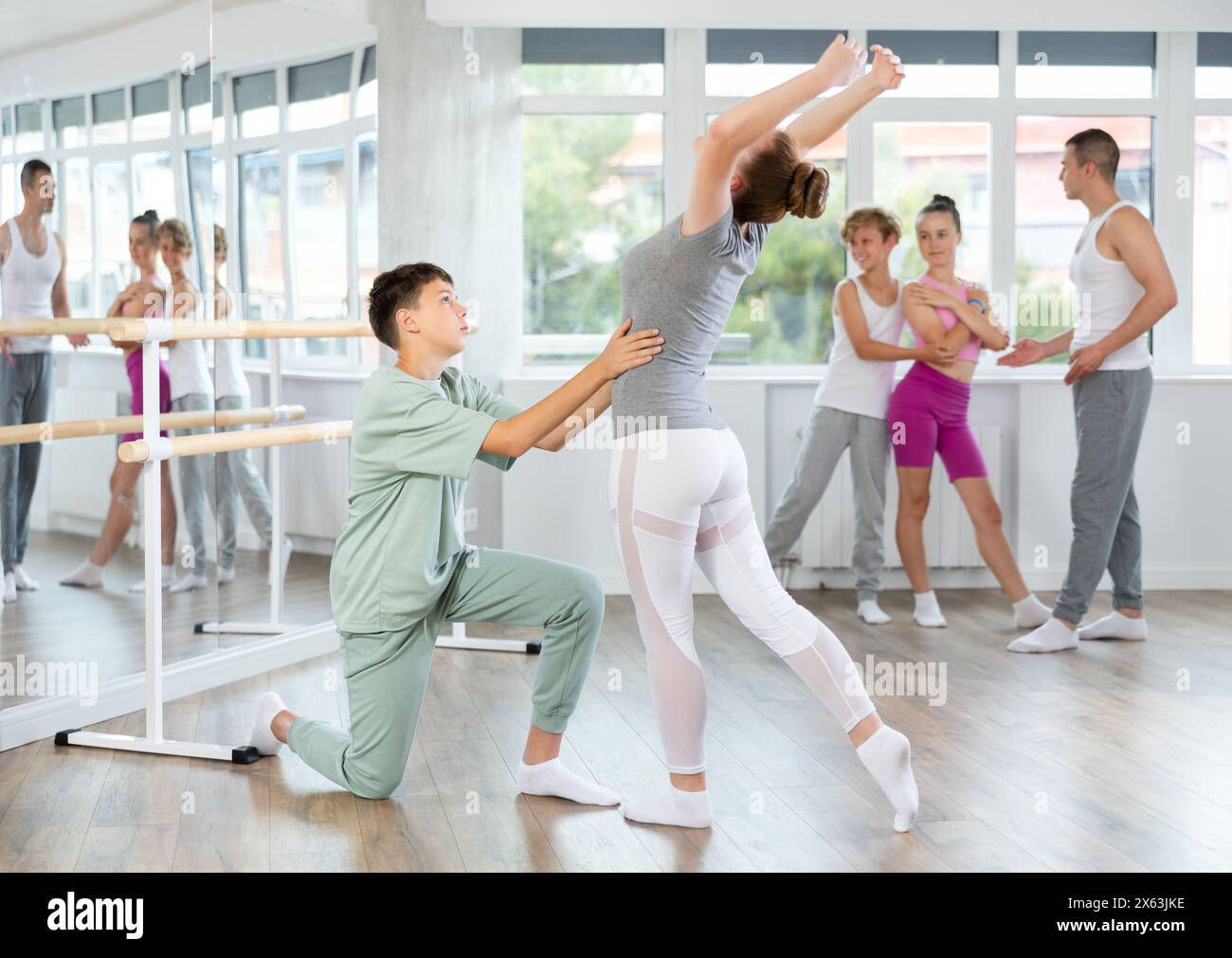 Boy and girl in pair train to perform ballet dance during rehearsal in ...