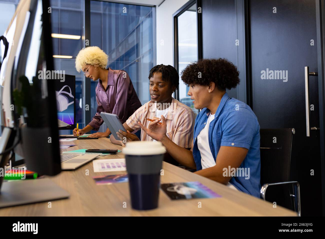 In modern office, a diverse young team collaborating Stock Photo - Alamy